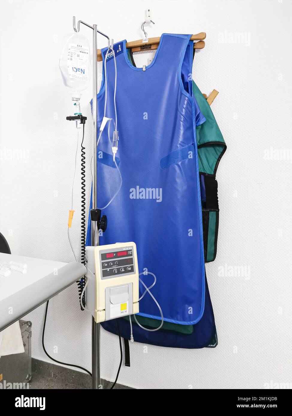 The veterinary practice with an apron for X-rays with a treatment table ...