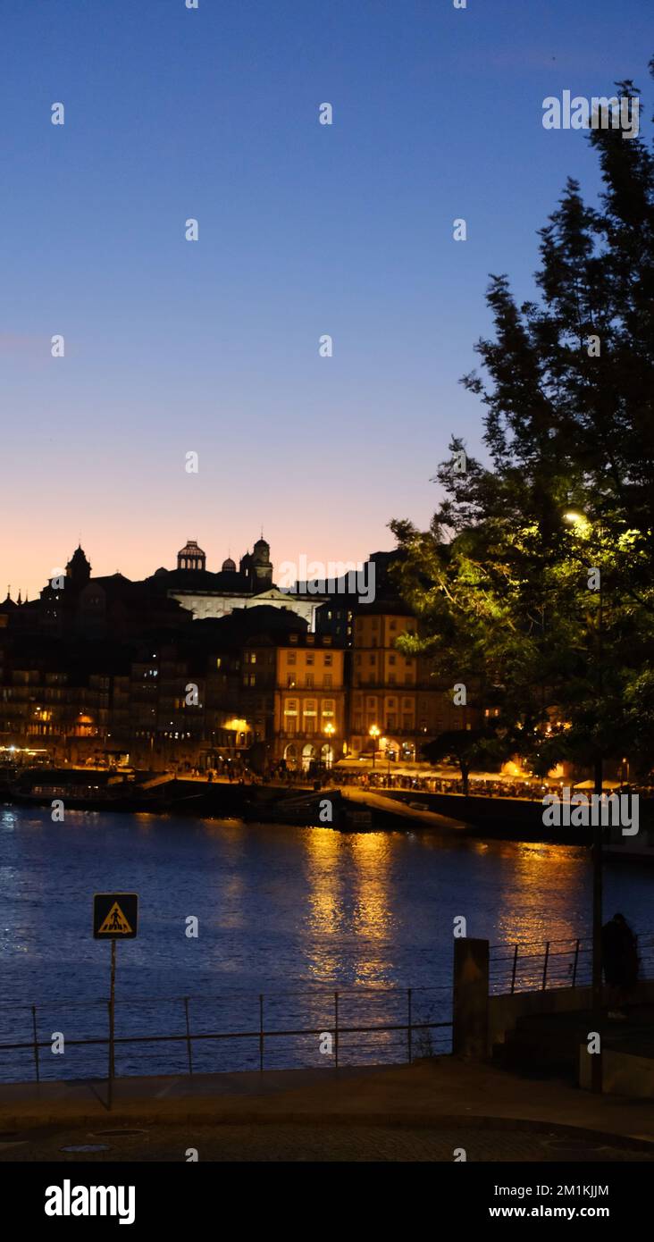 A beautiful vertical view of traditional buildings near a river in ...