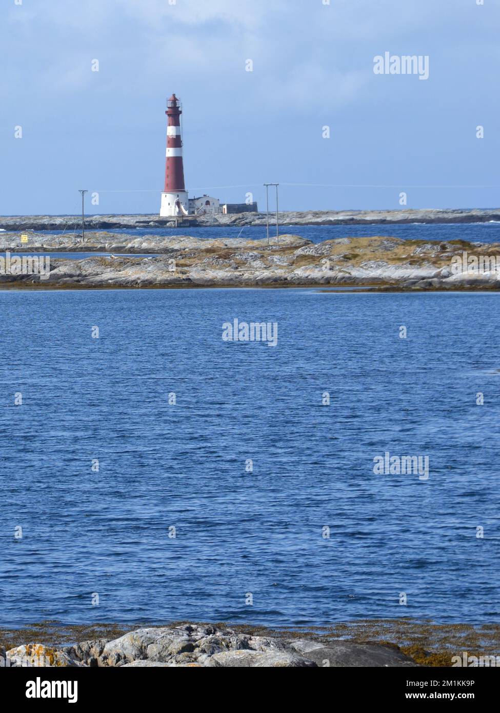 red and white lighthouse in blue sky horizon Stock Photo - Alamy