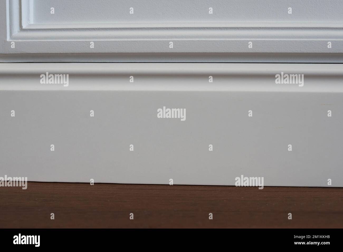 Matte wall, white baseboard and tiles Stock Photo - Alamy