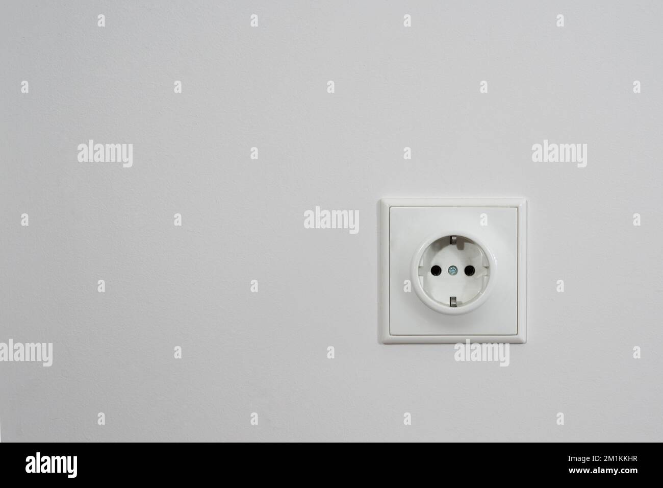 The electric socket on a white wall Stock Photo - Alamy