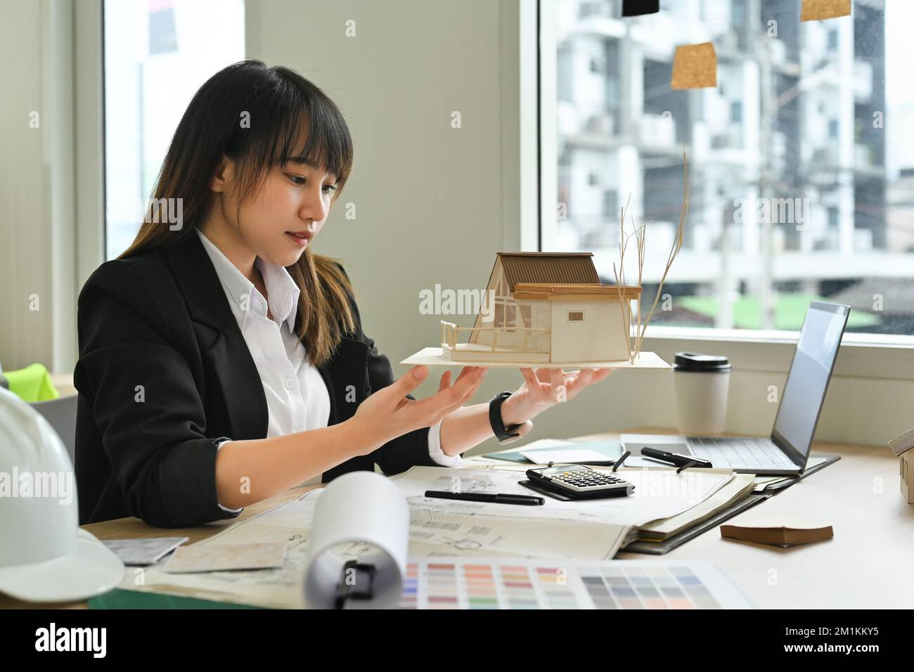 Beautiful architects woman working on design of a construction plan and ...