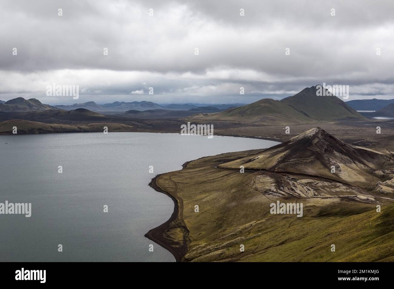 Dramatic Iceland scenery with a big lake and green mountains covered ...