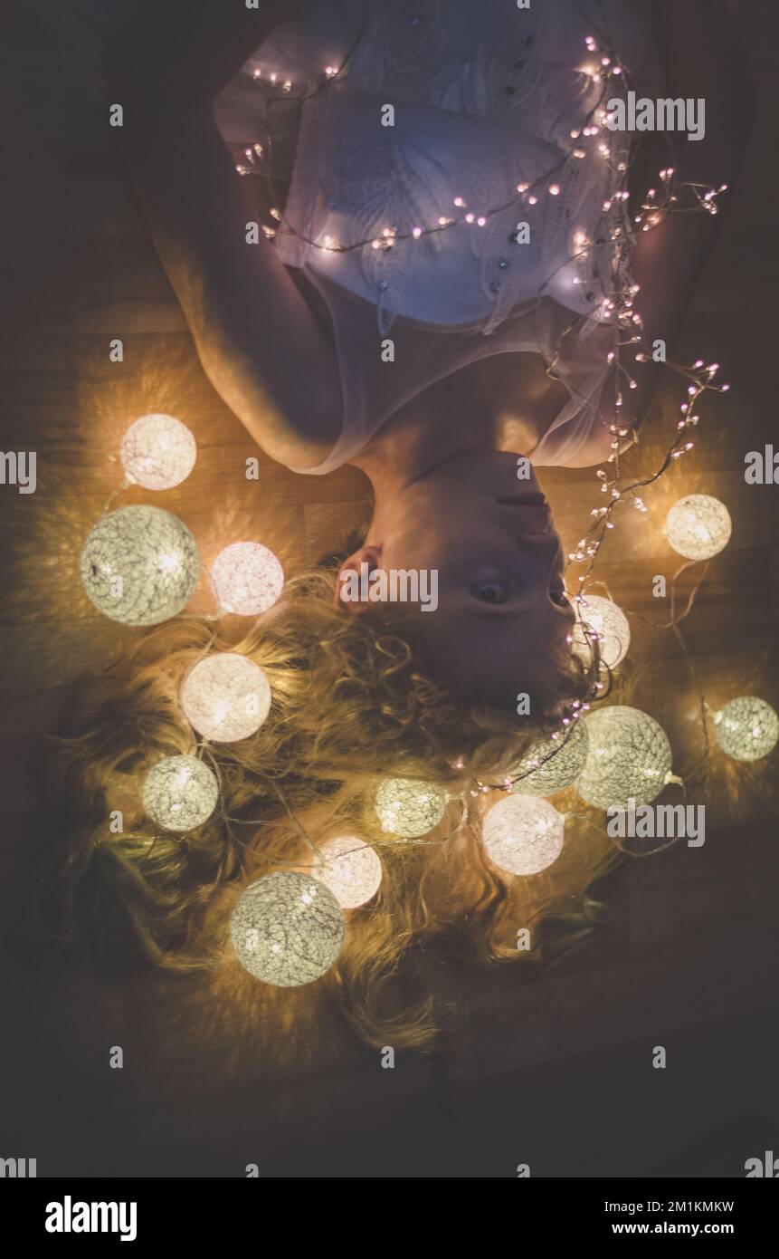 lovely girl in white dress illuminated with christmas tree lights Stock ...