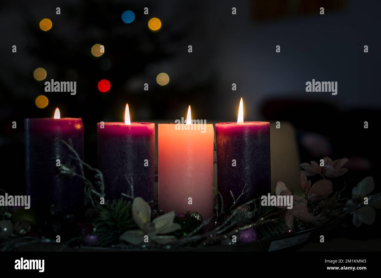 3 purple and 1 pink candles burning on advent wreath Stock Photo - Alamy