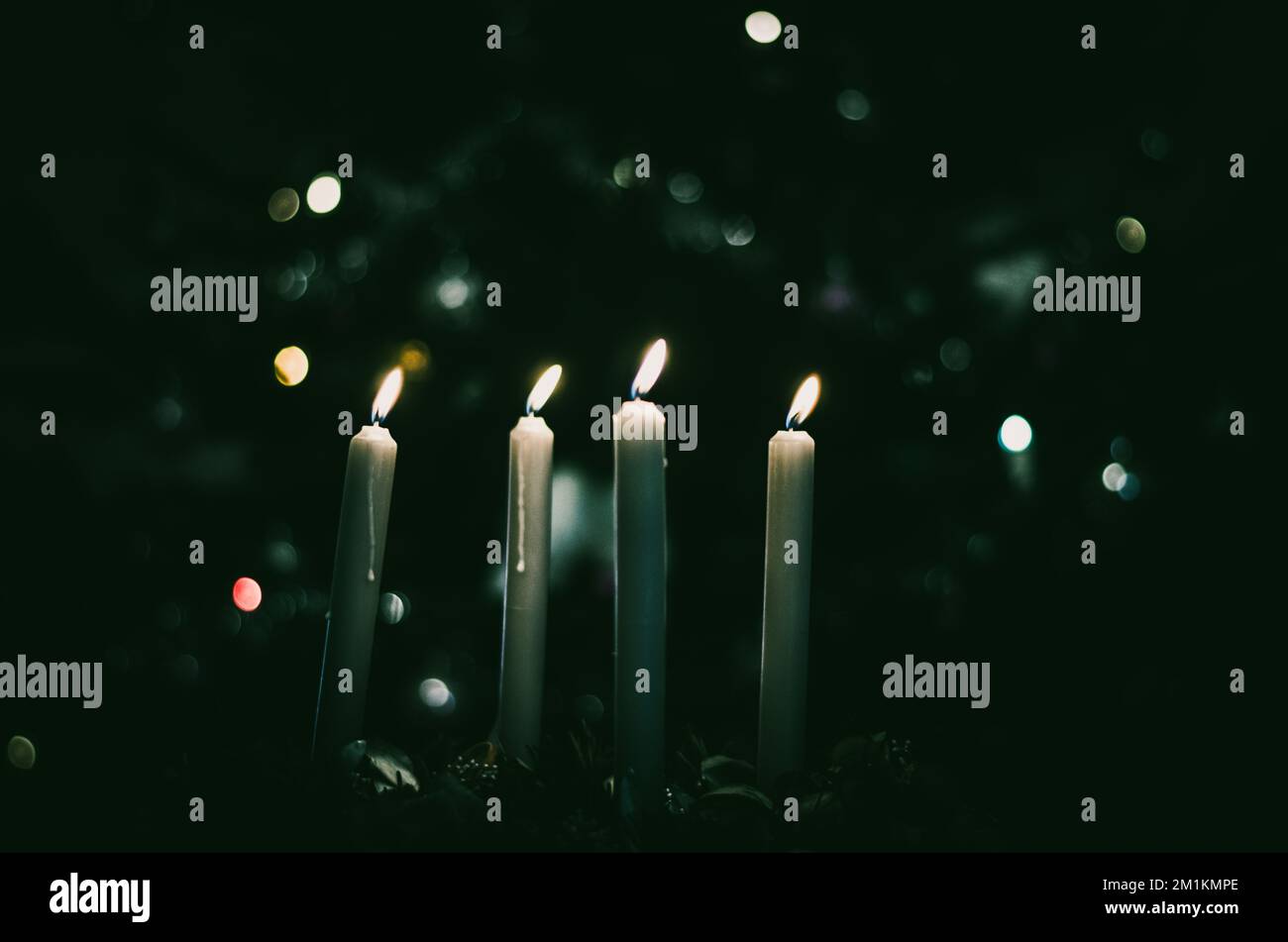 burning candles on advent wreaths with christmas tree background Stock ...