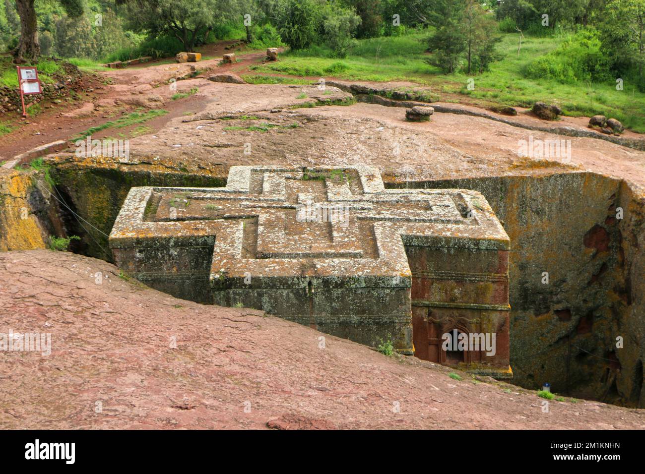 The cross-shaped Rock-hewn Church of Saint George surrounded by green ...