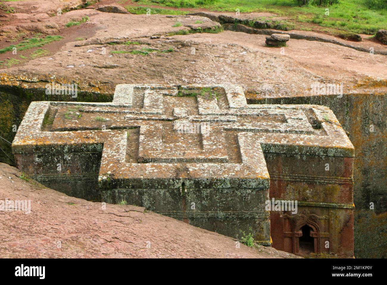The cross-shaped Rock-hewn Church of Saint George surrounded by green ...