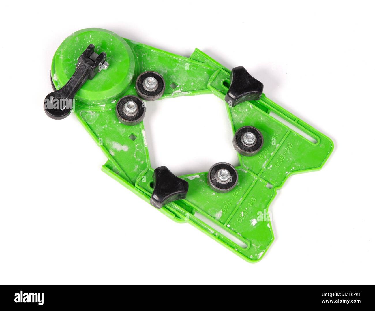Green tool for drilling a hole in a tile, isolated Stock Photo - Alamy