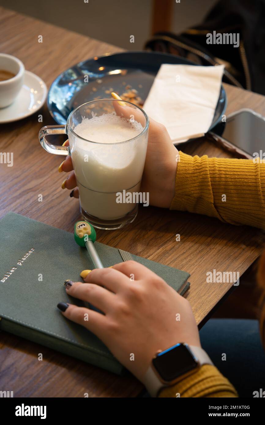 Pretty girl in autumn colors drinking latte Stock Photo - Alamy