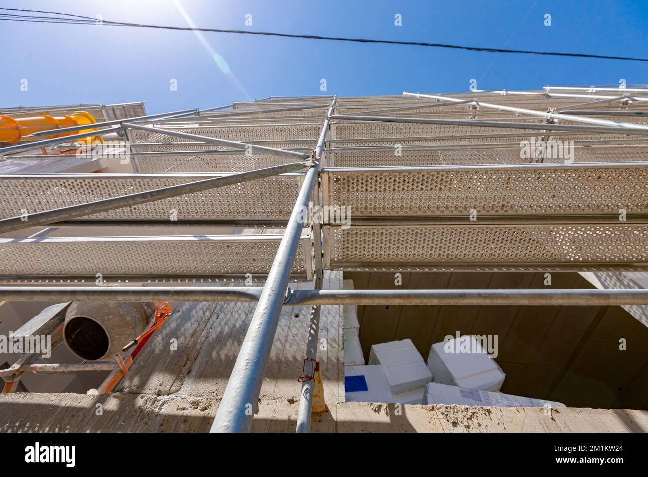 Shot from bellow on scaffolding mounted next to building under ...