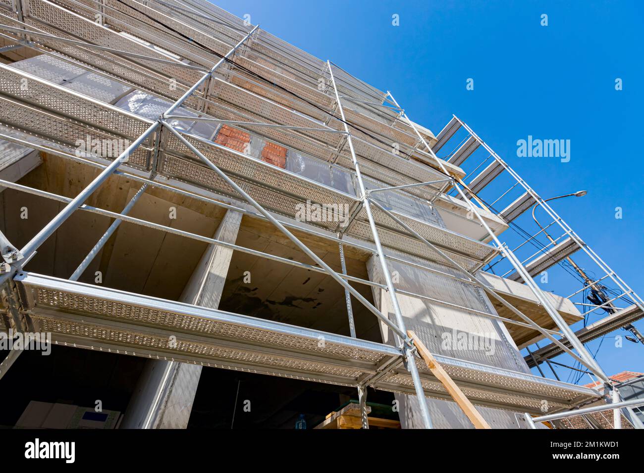 View from below on scaffold placed against unfinished edifice, new ...