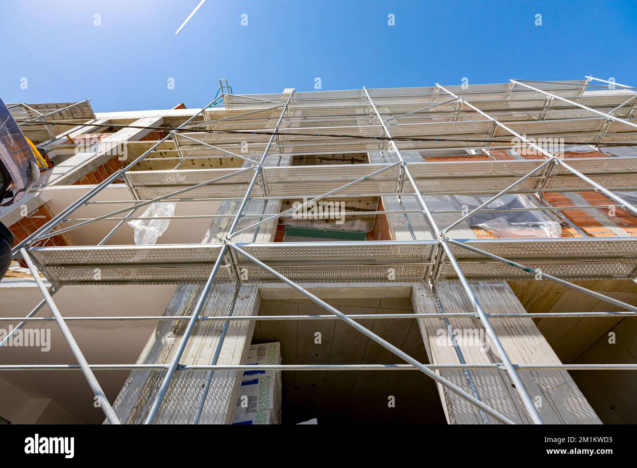 View from below on scaffold placed against unfinished edifice, new ...