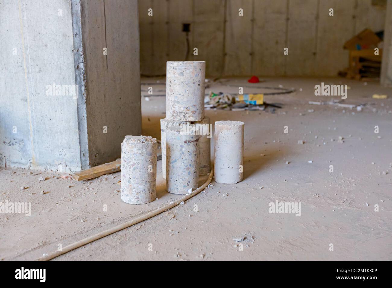 A few concrete cylindrical pillars placed on the floor of building ...