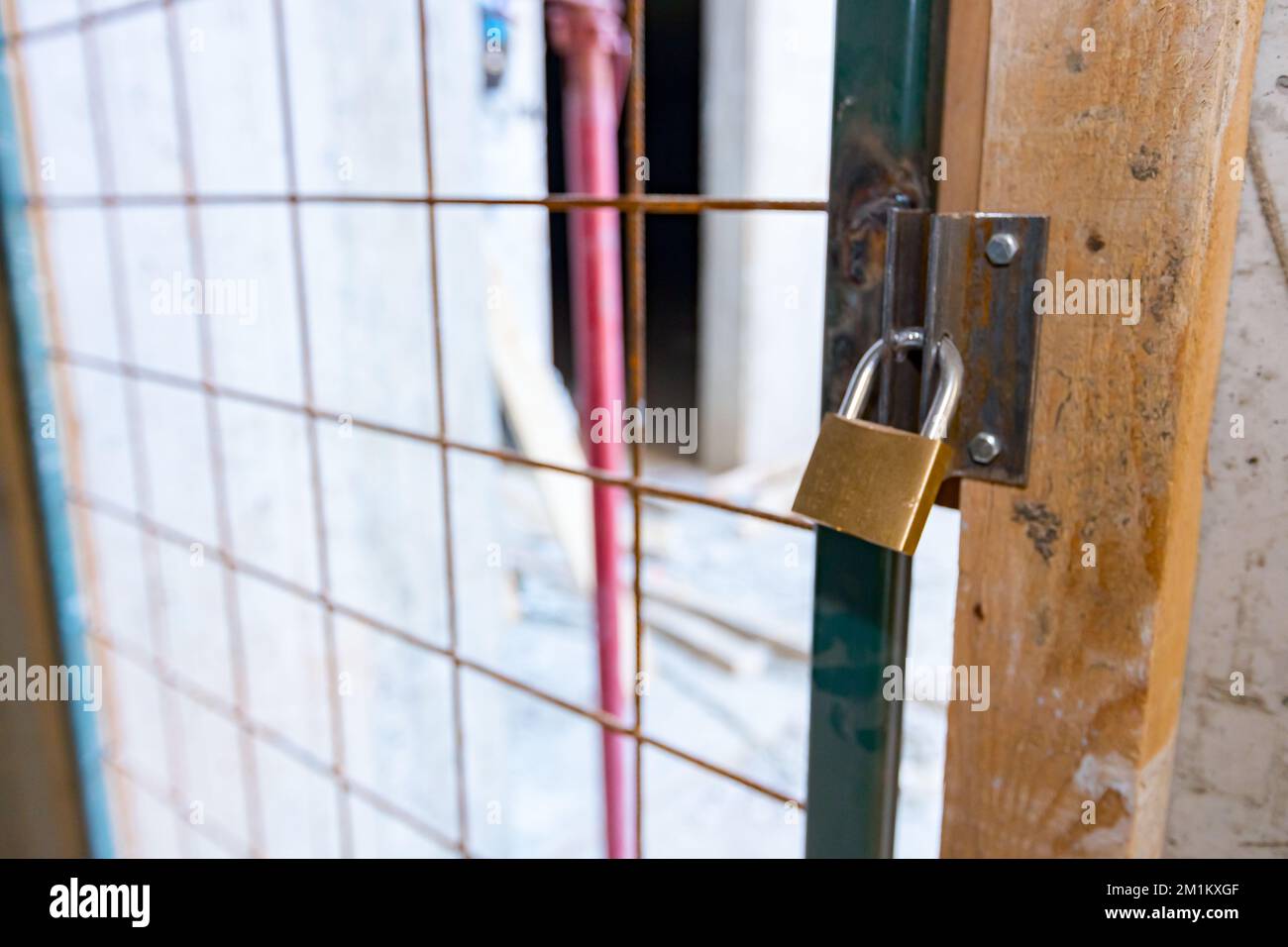 Close up view on metal lattice door, as a barrier, locked up with ...