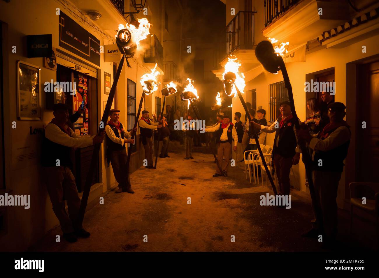 Villagers are seen holding torches on the street as they take part in ...