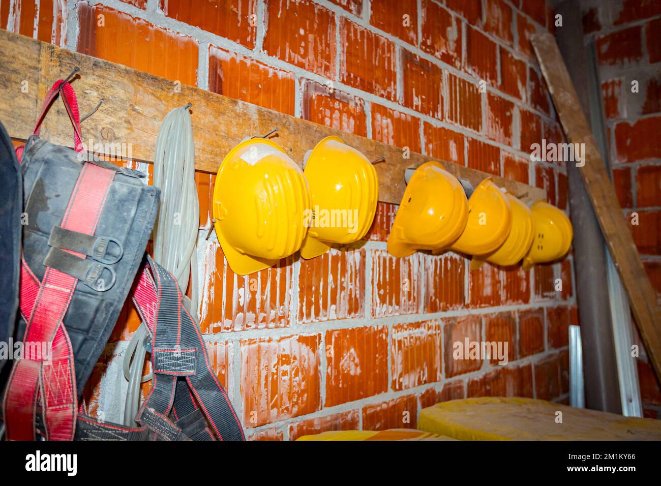 Workers' industrial work equipment, yellow helmets and safety belts ...