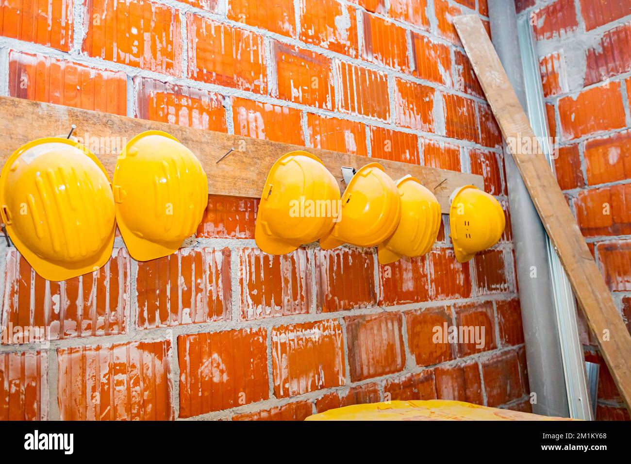 Workers' industrial work equipment, yellow helmets and safety belts ...