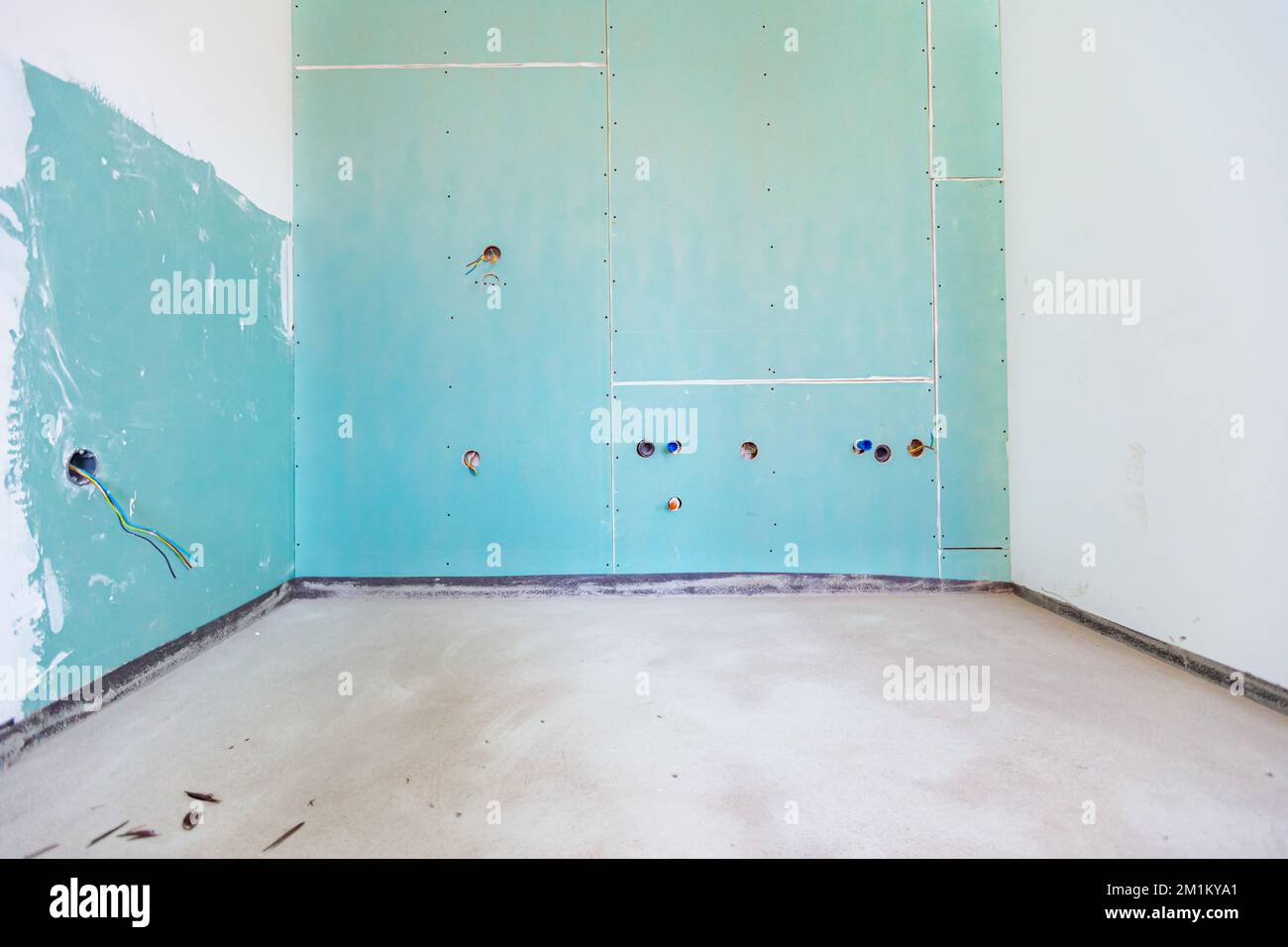 Exposed water and electricity connections installed on plaster wall of ...