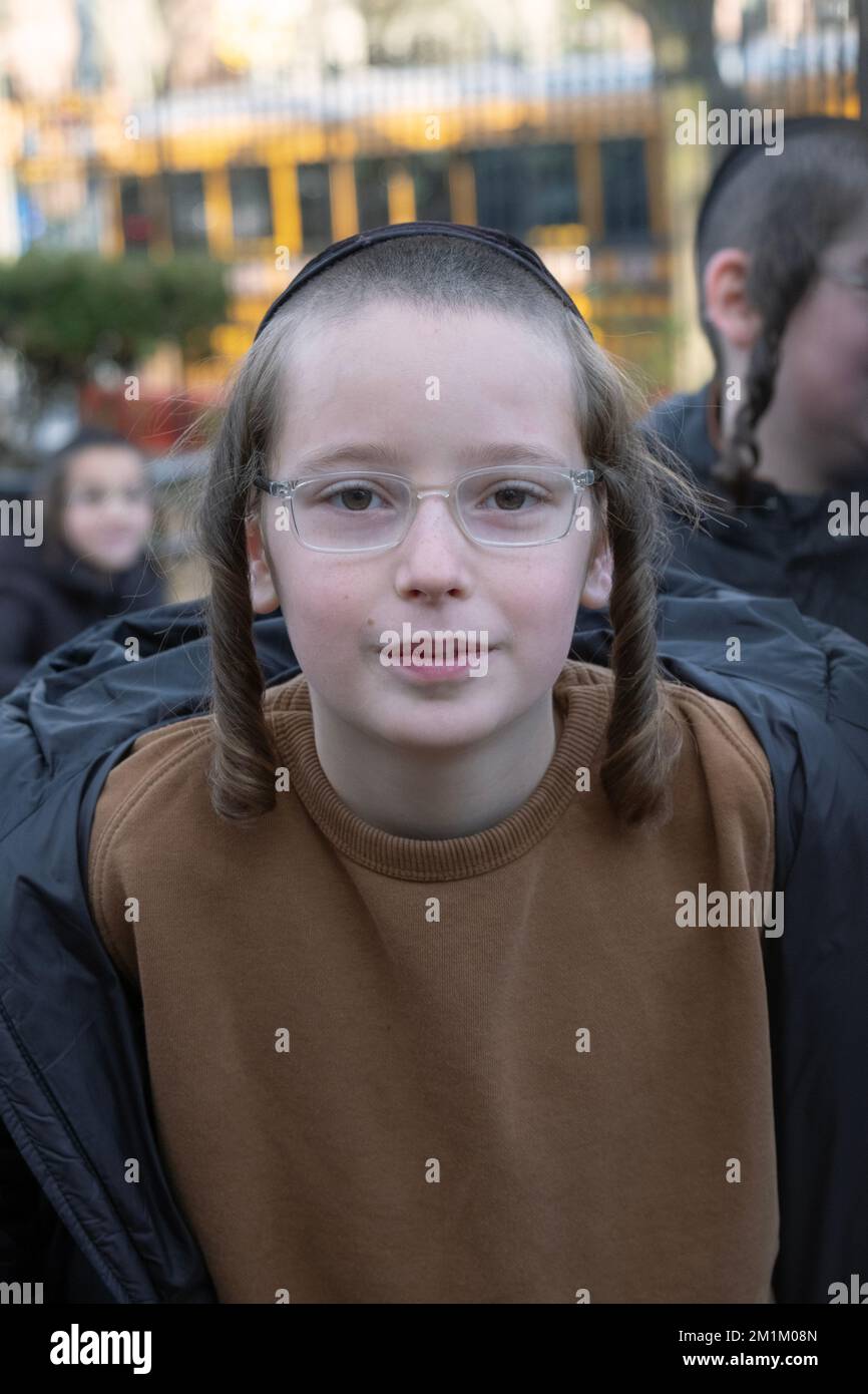 A young yeshiva student with long curly peyot poses for a head ...