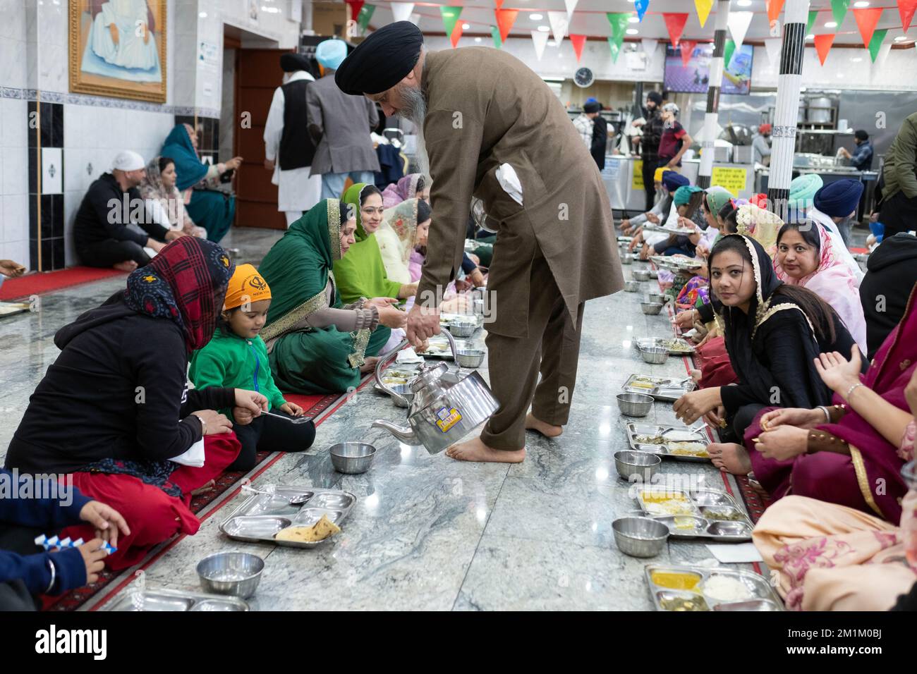 LANGAR. Volunteers at a Sikh temple distribute vegetarian food to ...