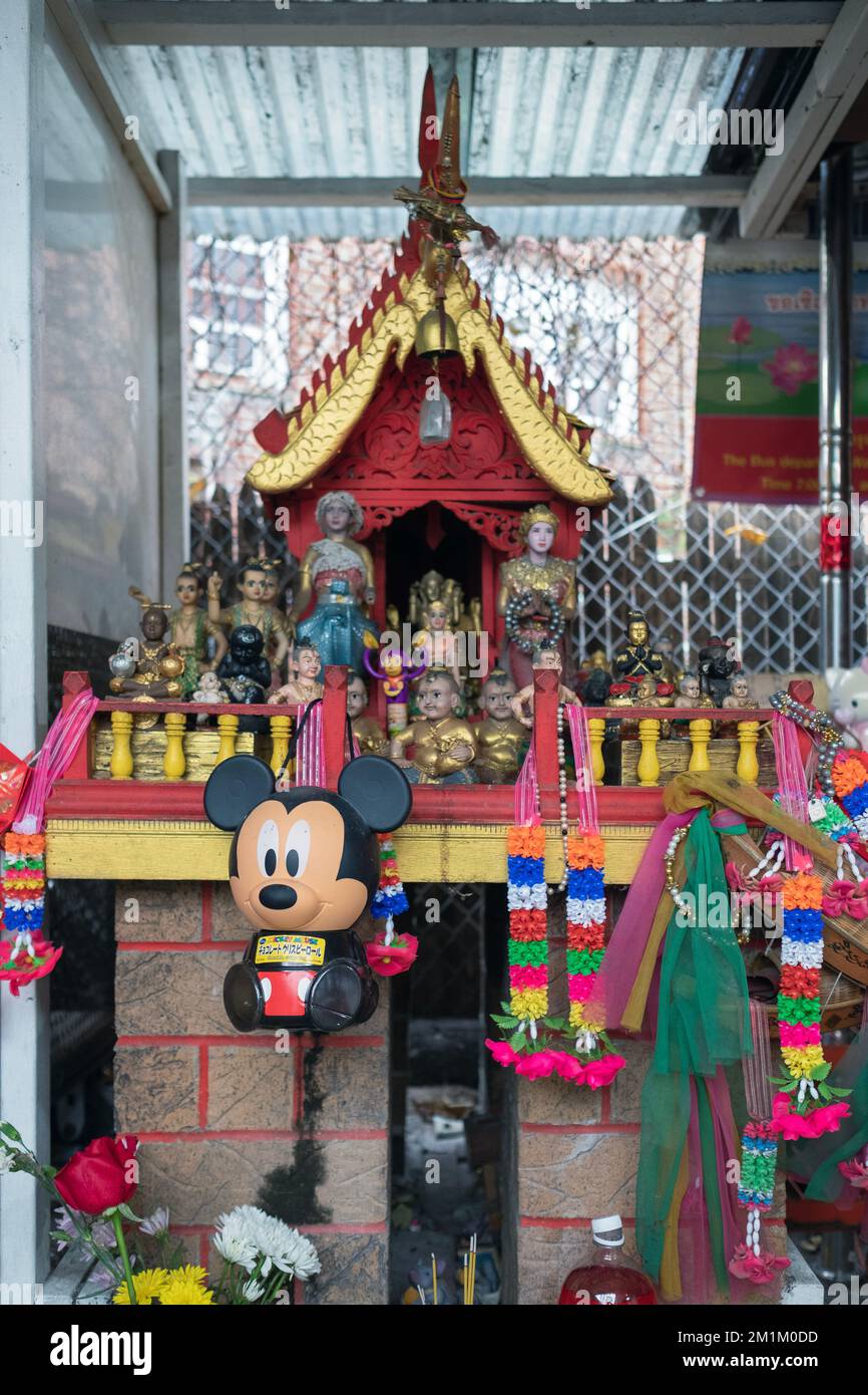 An array of religious statues and a small Mickey Mouse outside the Wat ...