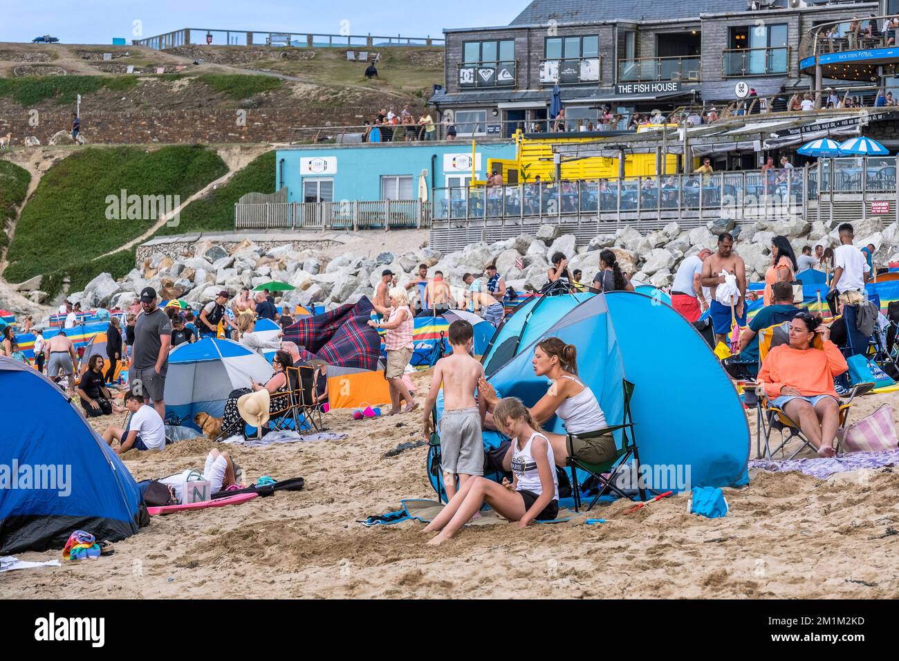 Holidaymakers on a busy crowded Fistral Beach in Newquay in Cornwall in ...