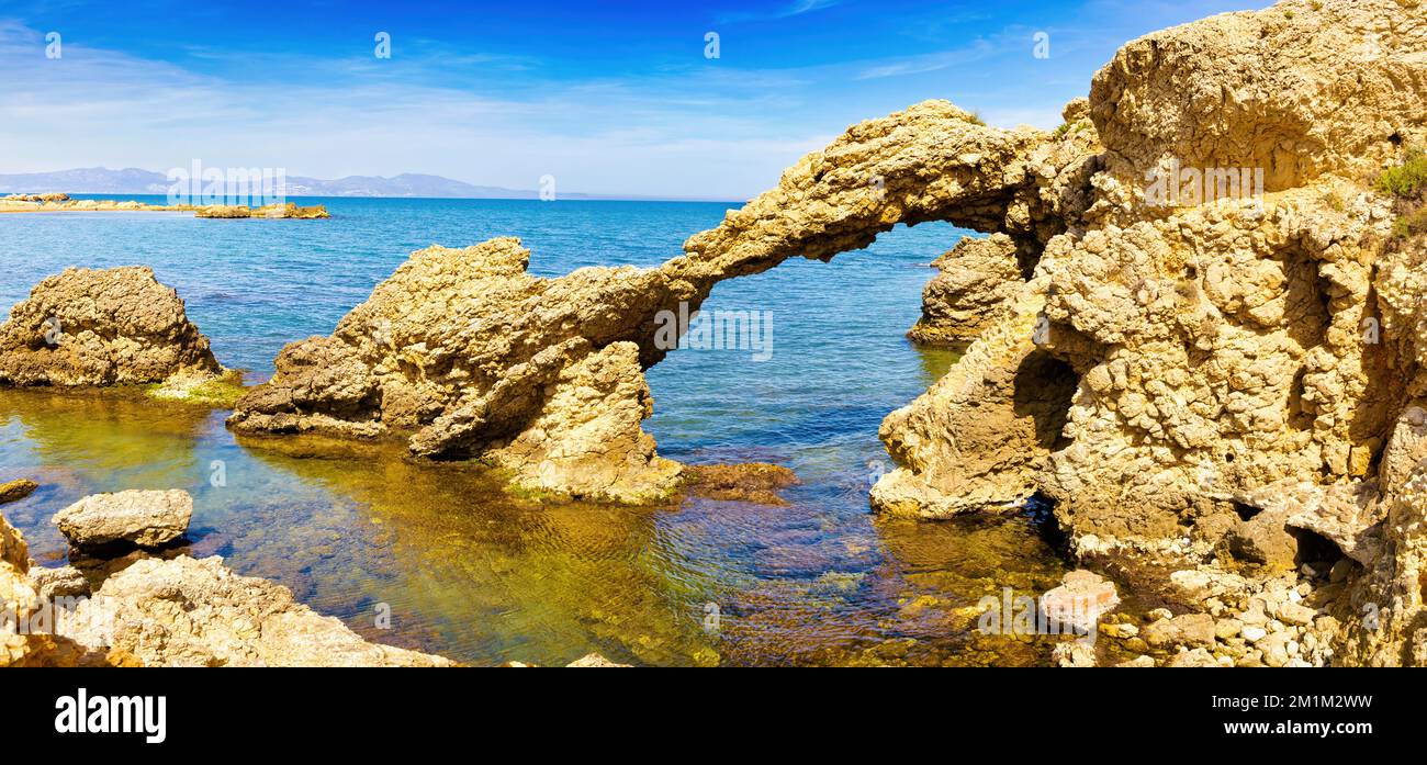 View of the holed rock of Portitxol located on the coastal path from La ...