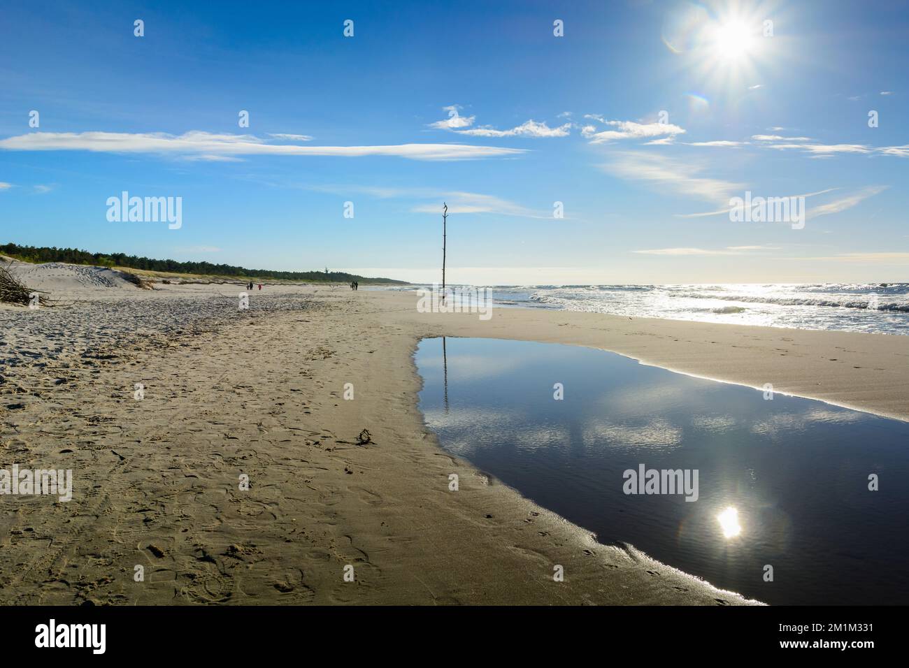 Amazing beach sunny day with endless horizon and lonely figures in the ...
