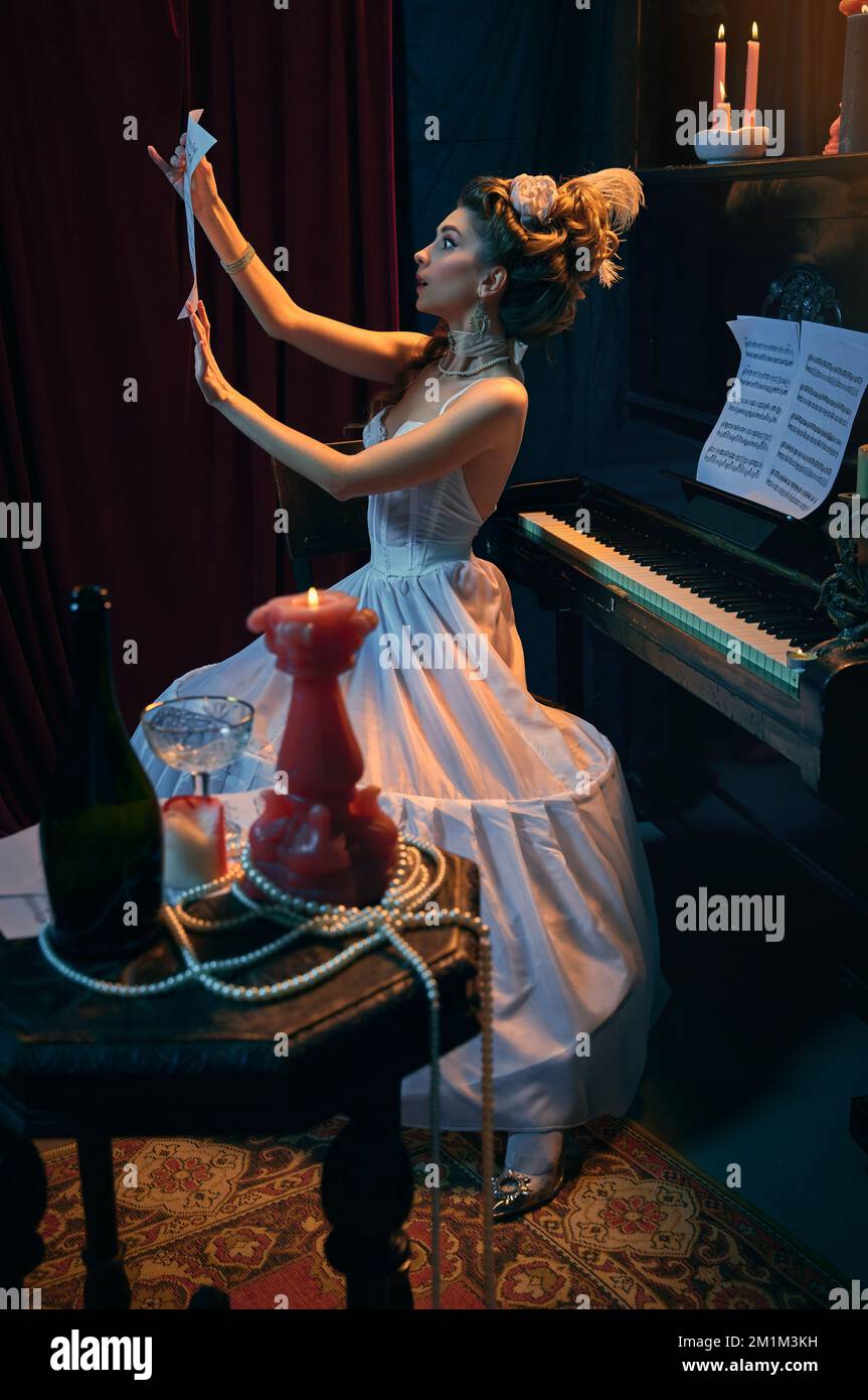 Portrait of young girl in image of medieval princess in white dress ...