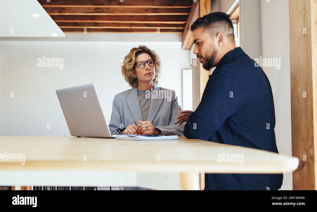 Professional business people talking about a project in an office ...