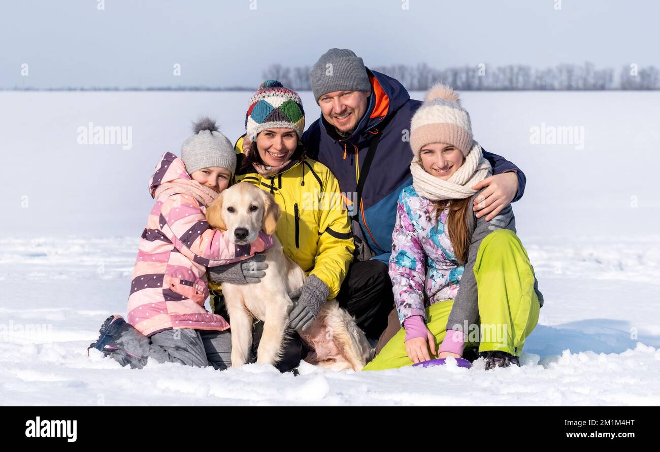 Happy family with golden retriever dog Stock Photo - Alamy