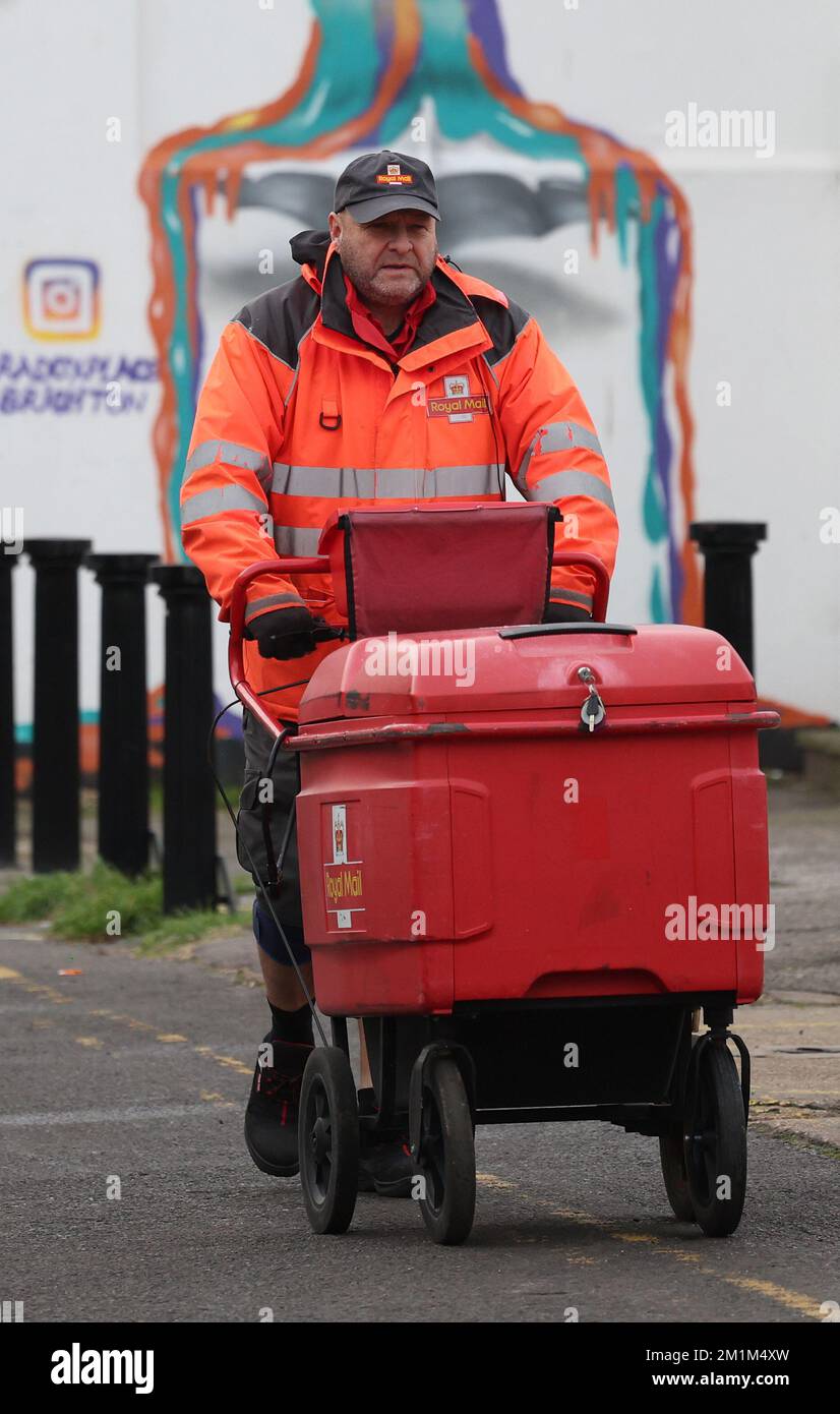 A postman pushing his cart down a street in the North Laine area of ...