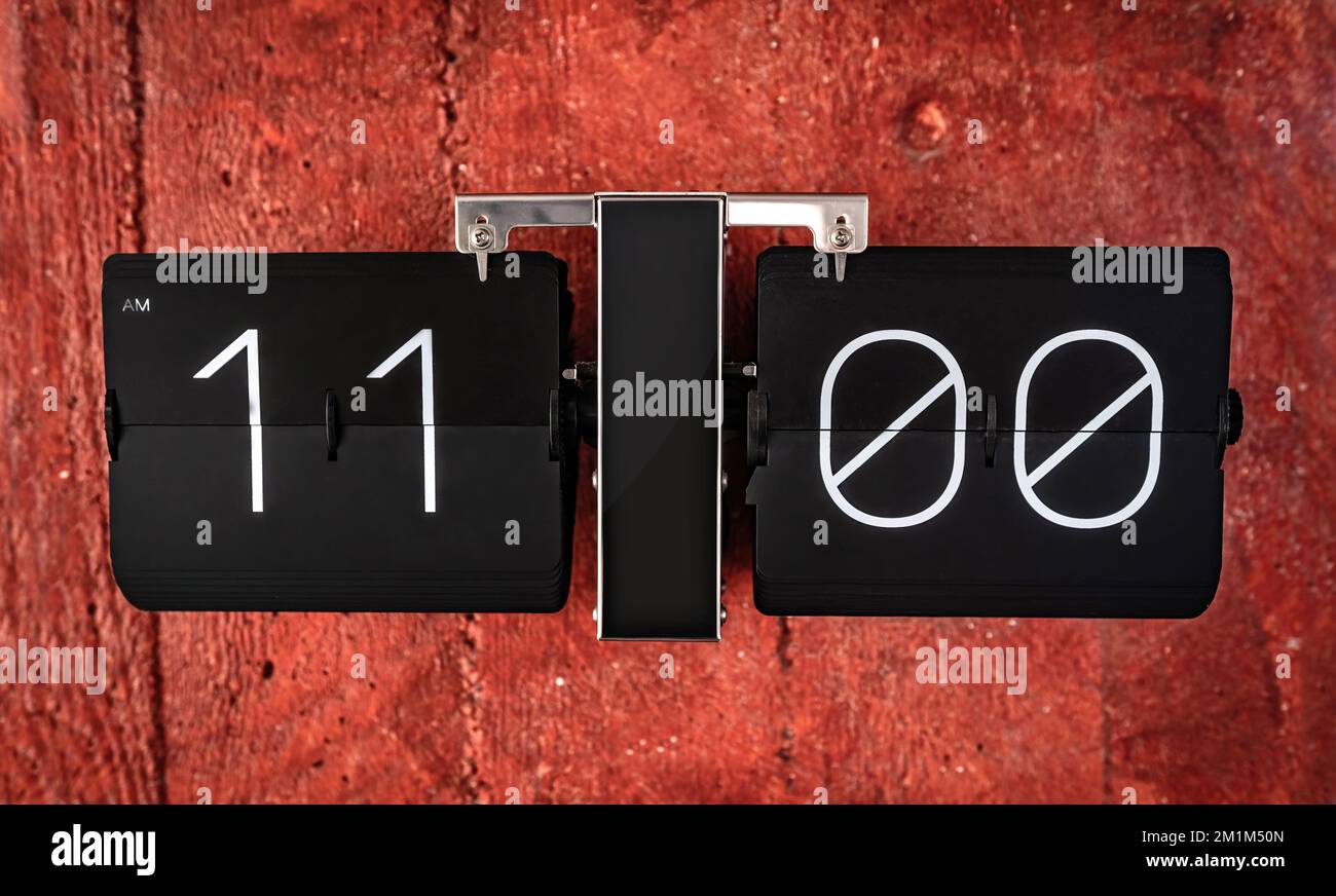 Flip black clock with eleven o'clock time on panel closeup Stock Photo ...
