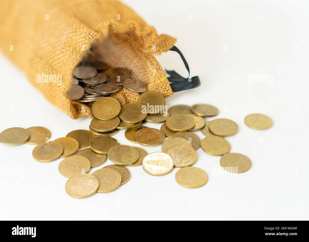 Old sack purse filled with gold coins money isolate white background ...