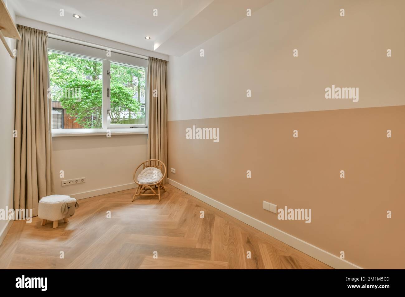 an empty room with wood flooring and beige walls, white trim around the ...