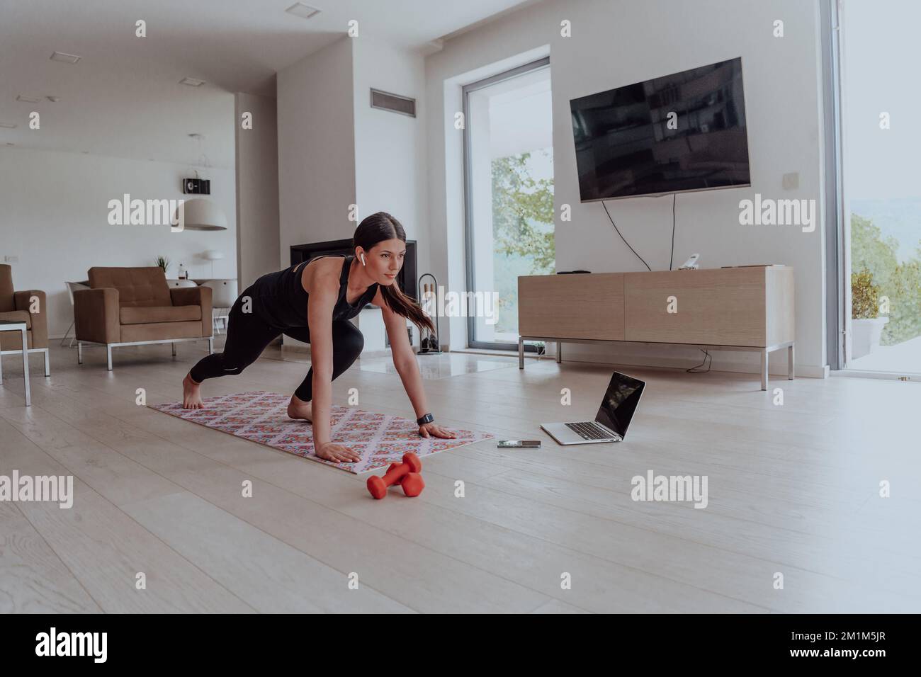 Young Beautiful Female Exercising, Stretching and Practising Yoga with ...