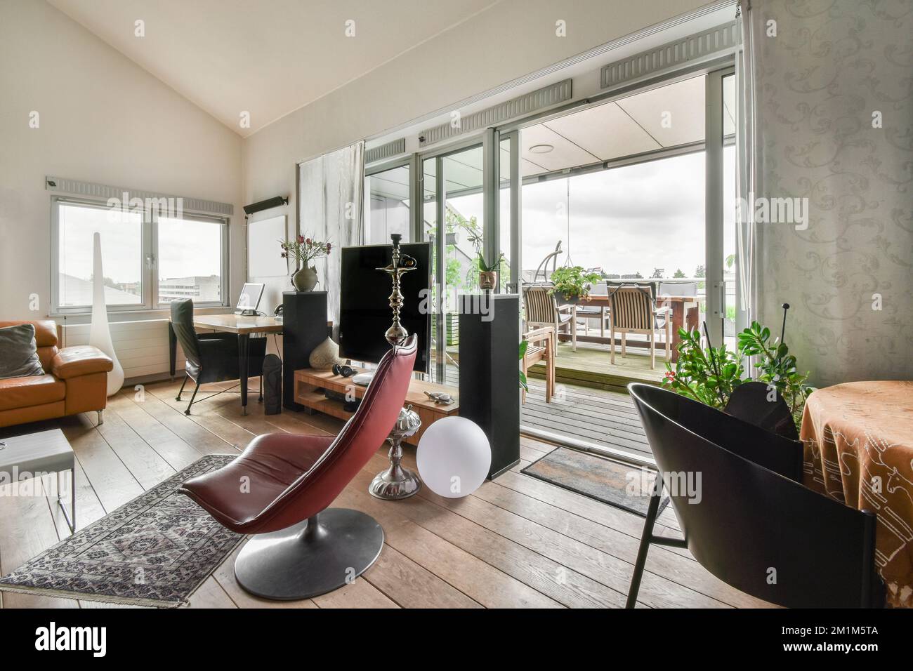 a living room with wood flooring and large sliding glass doors that ...