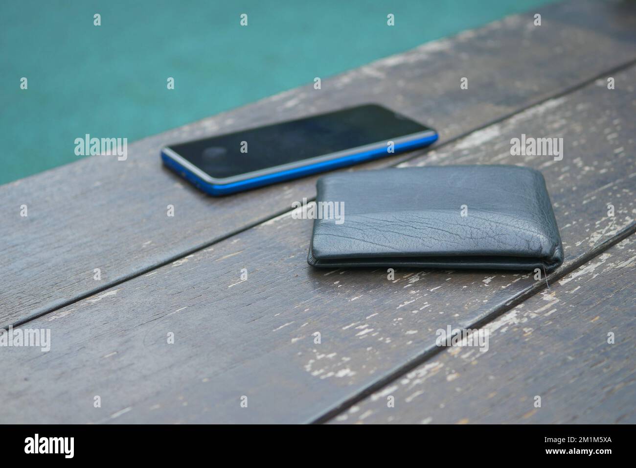 left wallet on a bench in the park Stock Photo - Alamy