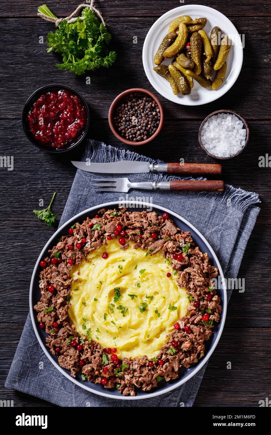 Reindeer Stew with Lingonberries and potato puree on plate on wood ...
