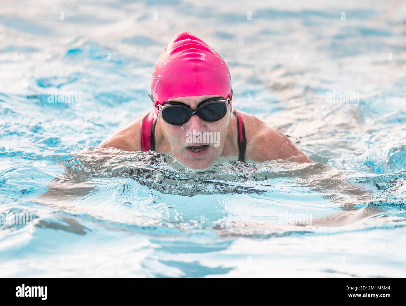 A swimmer at Hathersage Swimming Pool in the Peak District as snow and ...