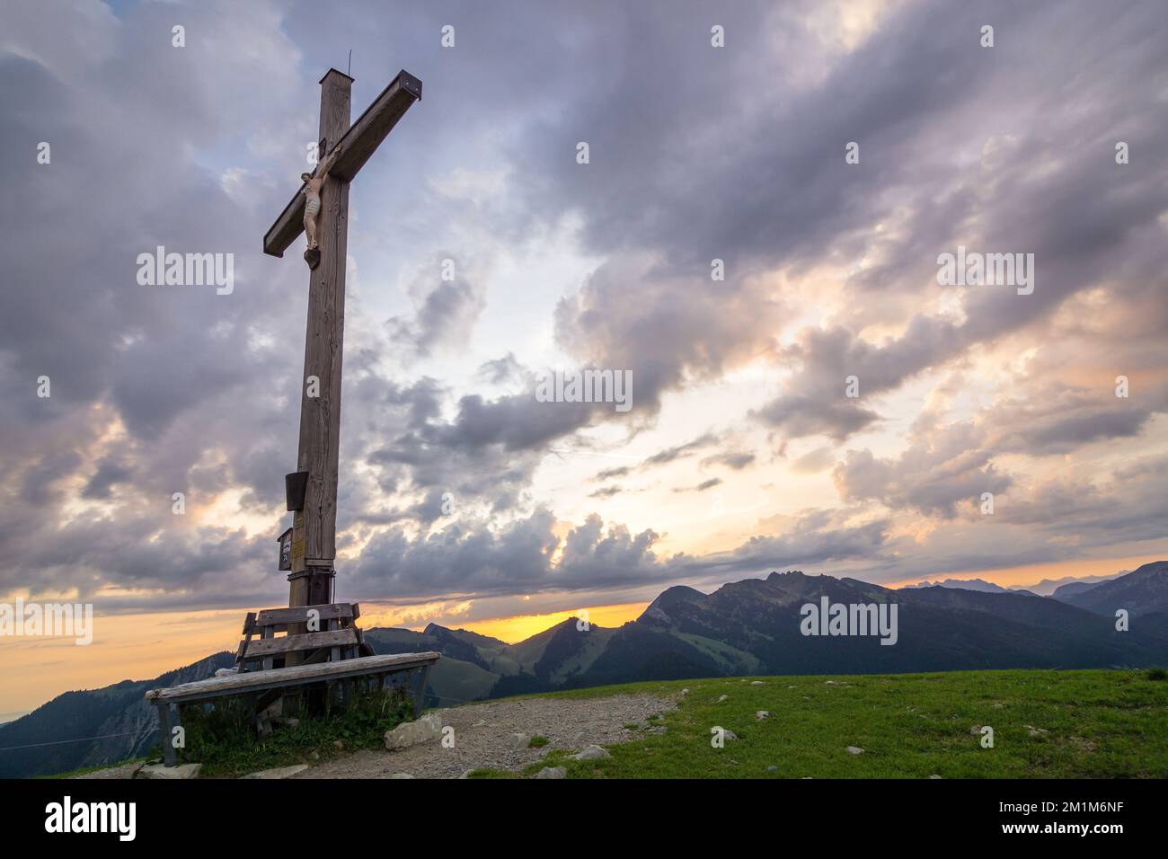A summit cross with a view and evening sky Stock Photo - Alamy