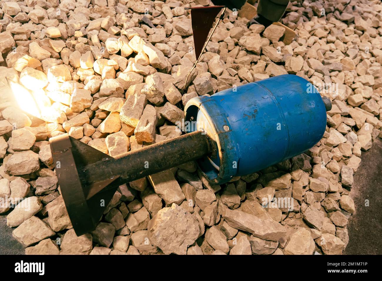 An unexploded mortar mine lying on the rocks. Clearance of unexploded ...