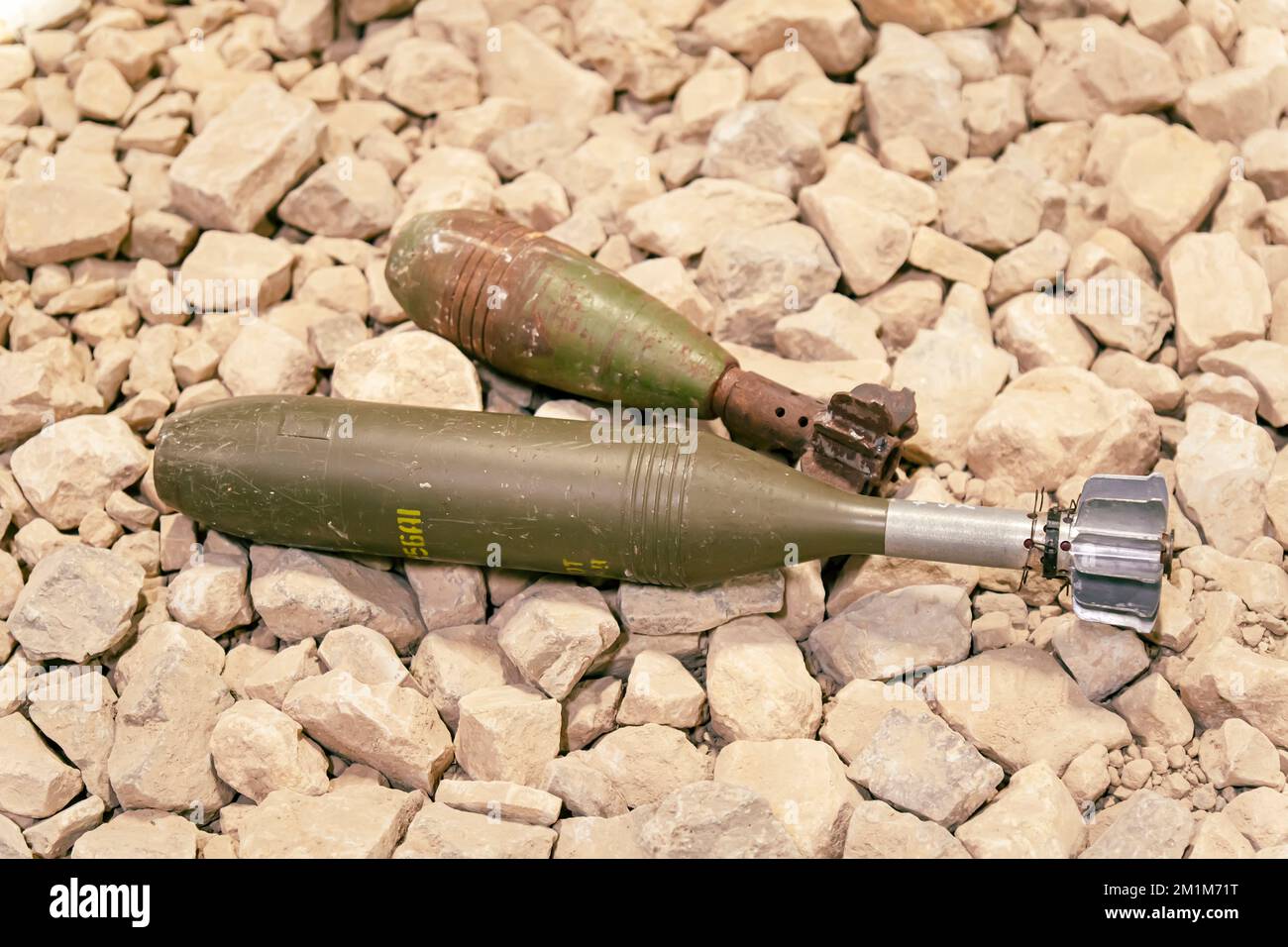 An unexploded mortar mine lying on the rocks. Clearance of unexploded ...