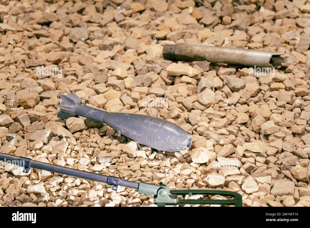 An unexploded mortar mine lying on the rocks. Clearance of unexploded ...