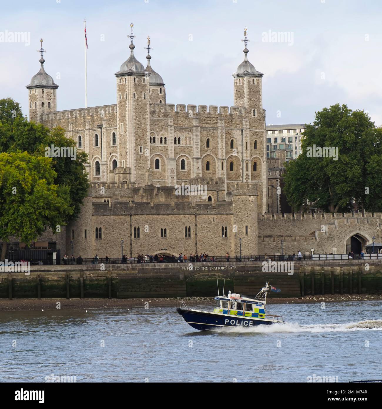 Thames river police launch passes the White tower, Tower of London at ...