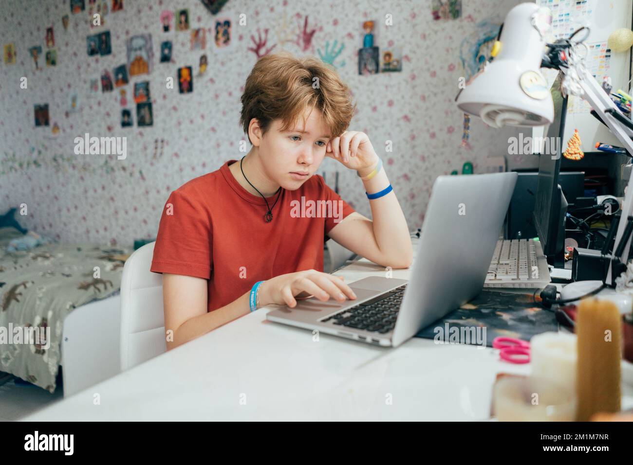 Teenage girl studying remotely using a laptop. Online education. E ...