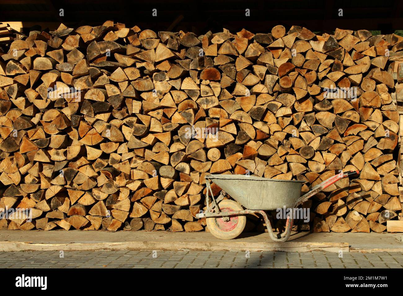 Stack Of Firewood And Dirty Wheelbarrow Stock Photo - Alamy