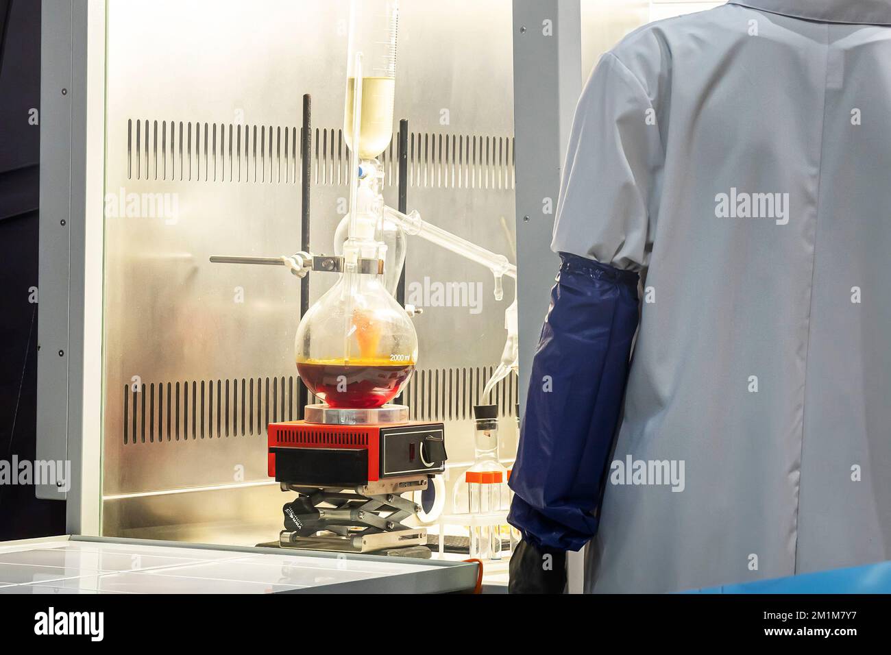 Biochemical laboratory. Scientists in a chemical protection suit create dangerous chemical ...