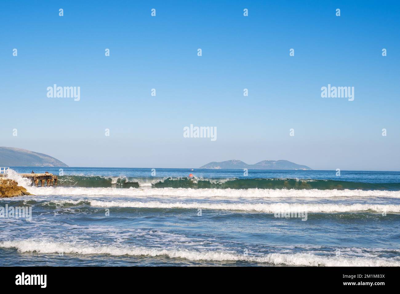 Bright blue ocean in a clear blue sky, with islands on the horizon ...